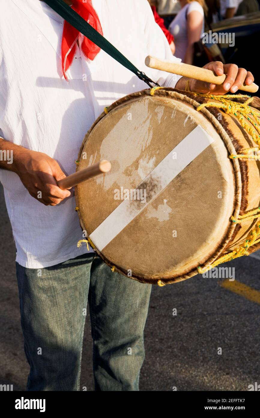Mid section view of a man playing a drum with sticks Stock Photo - Alamy