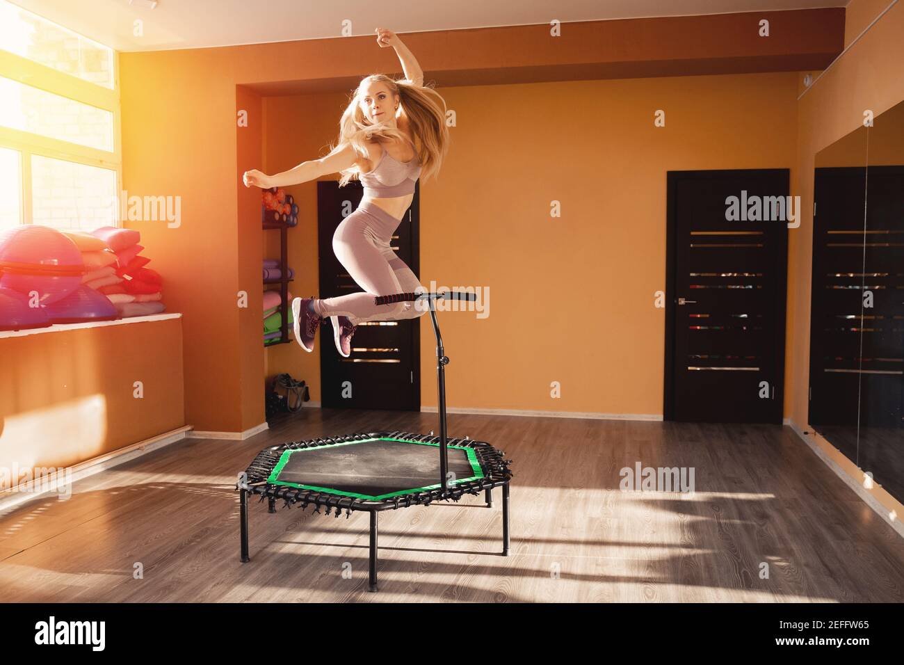 Fitness women jumping on mobile mini trampolines, workout gym movement ...