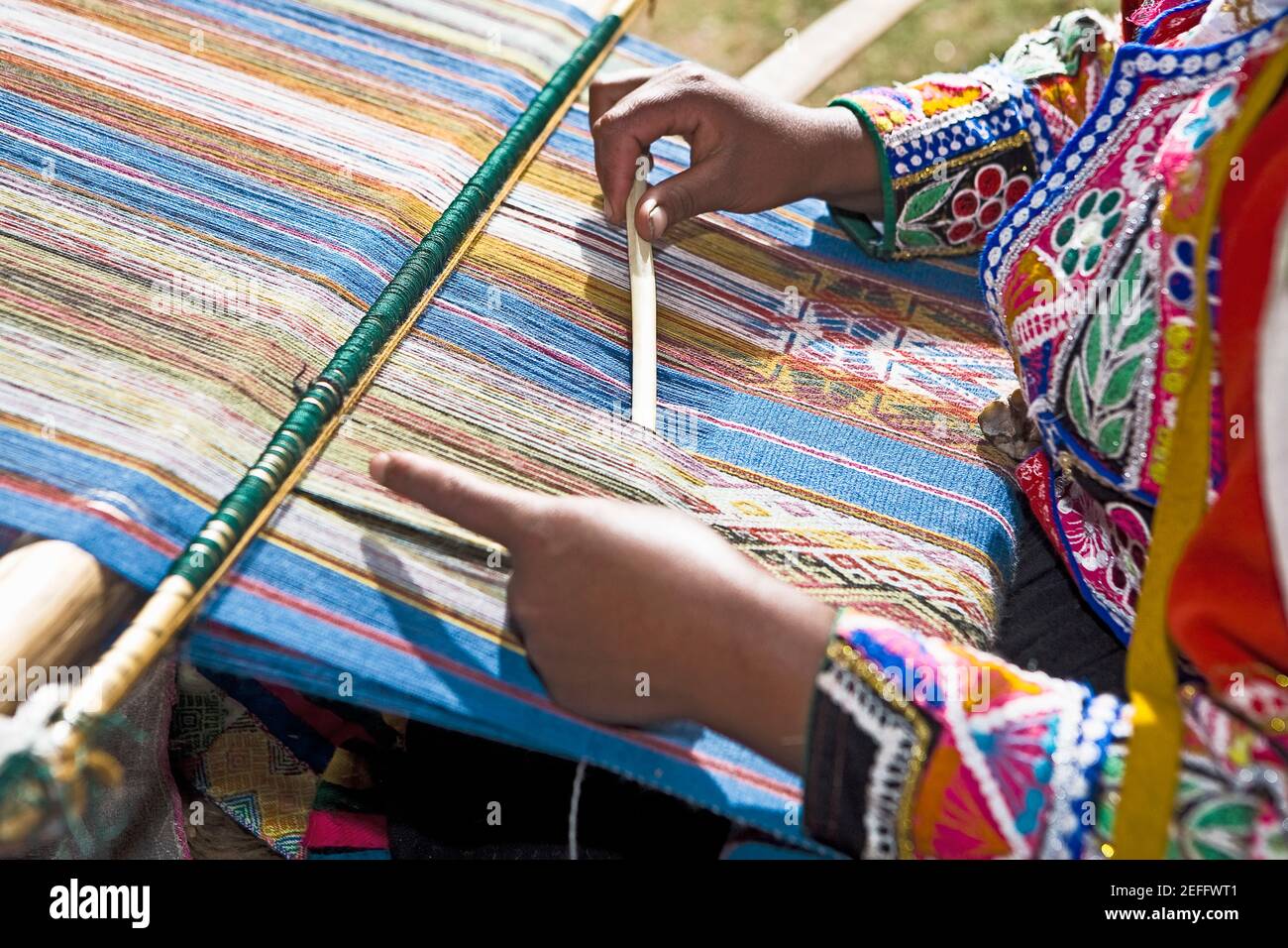 Mid section view of a woman weaving in a loom, Aguanacancha, Peru Stock ...