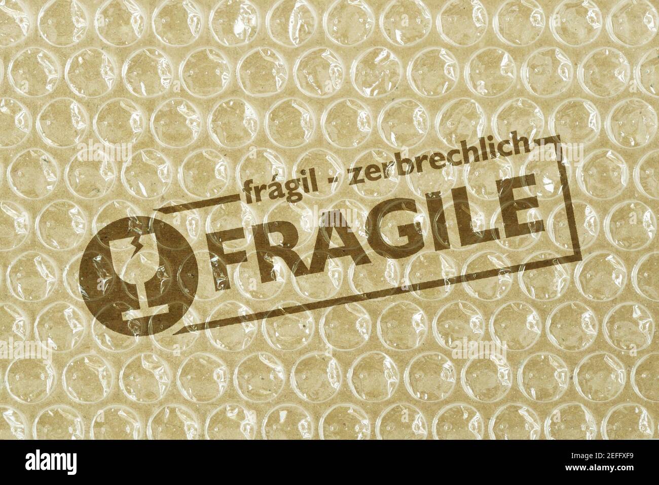 The word Fragile on plastic bubble wrap background - Concept of ...