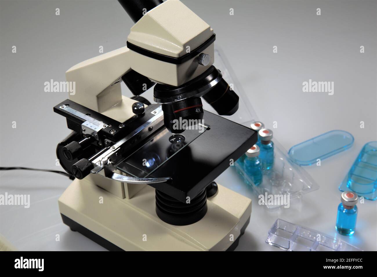 scientist looking through microscope Stock Photo - Alamy