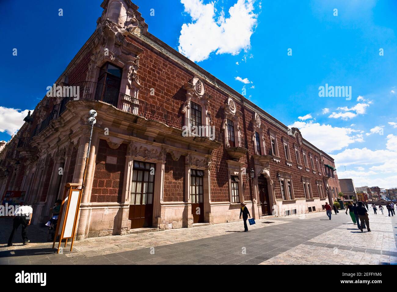 Group of people walking in front of a government building, Palacio De ...