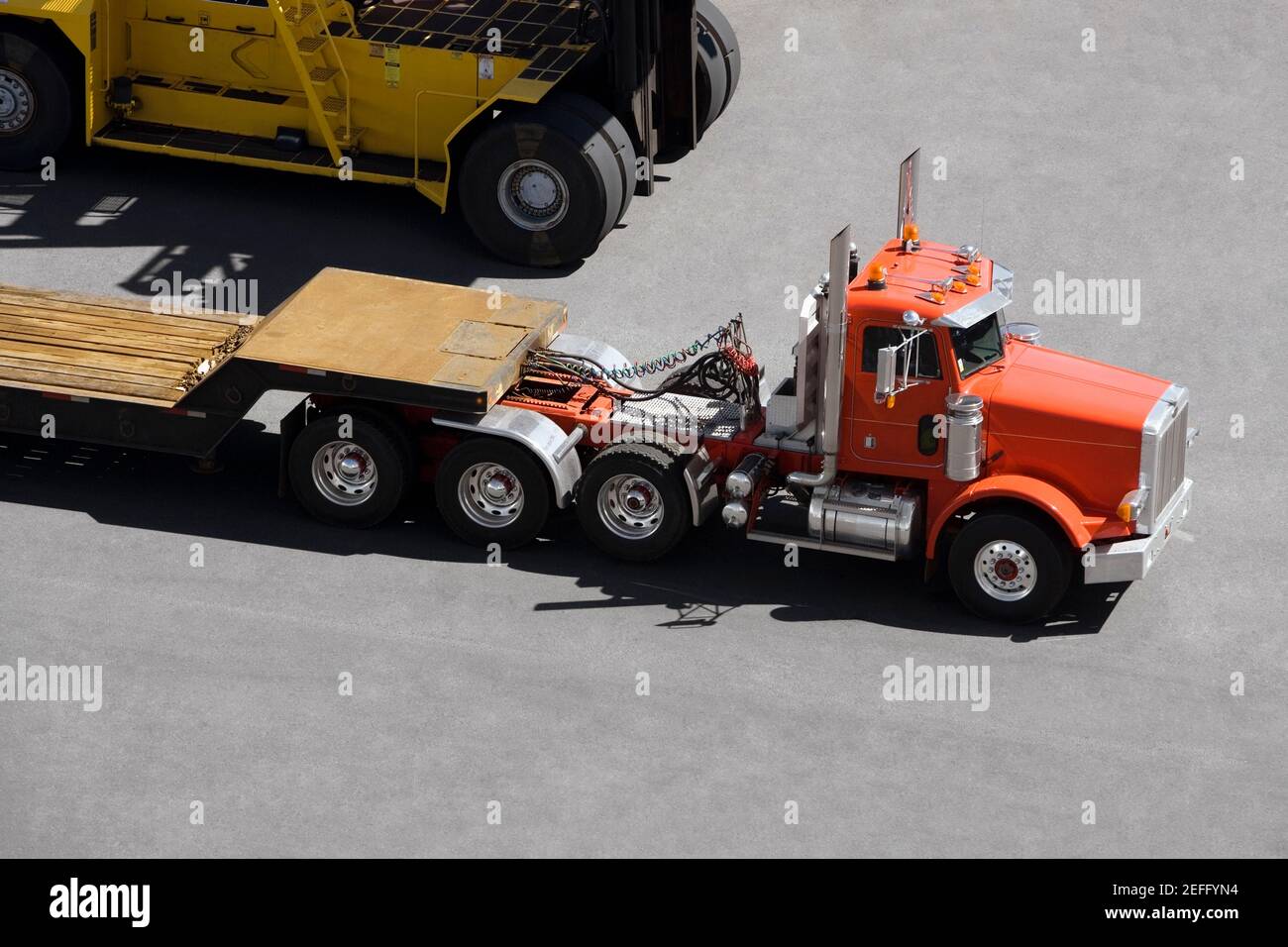 High angle view of a semi-truck and a forklift at a commercial dock ...
