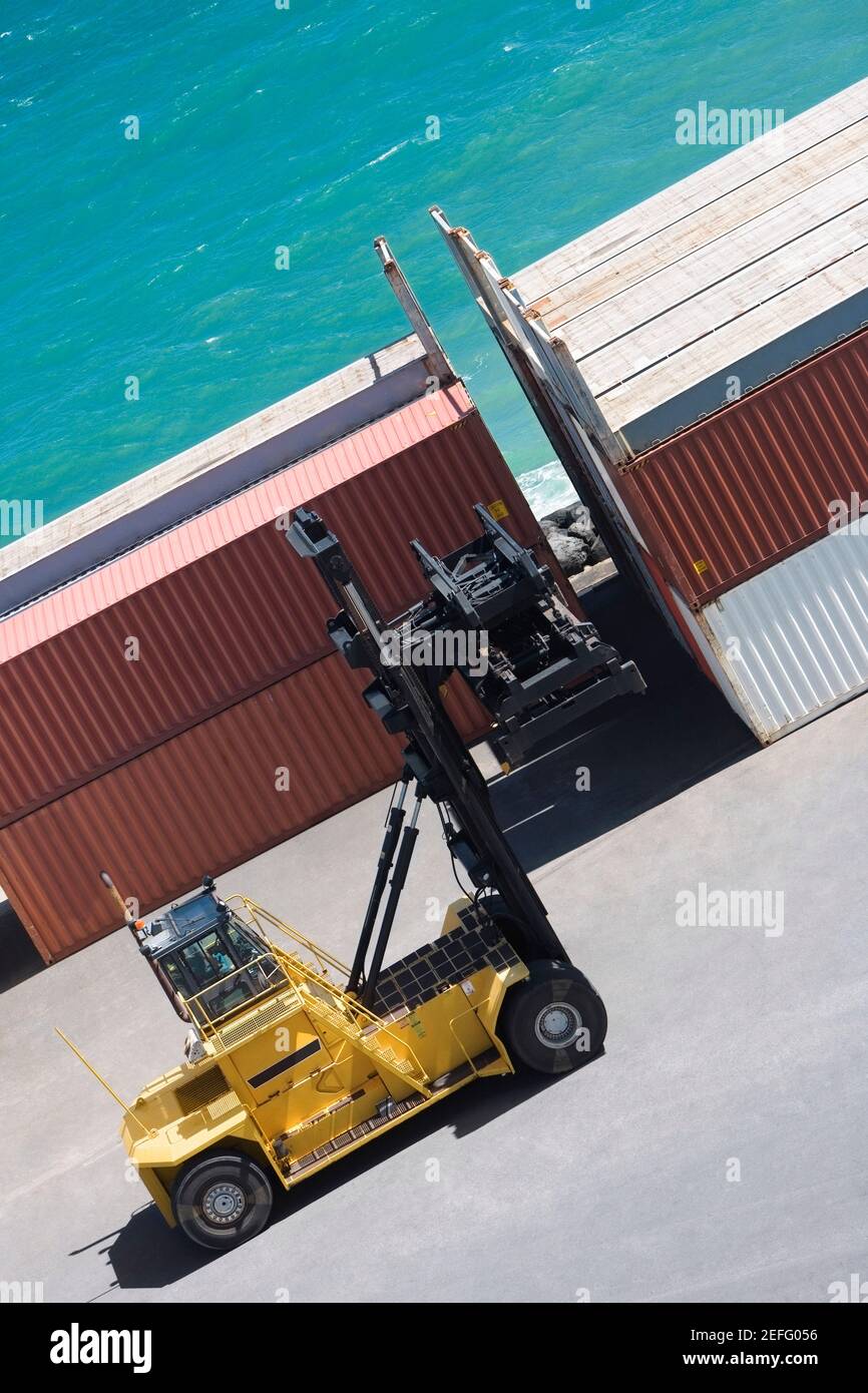 High angle view of a forklift in front of cargo containers at a ...