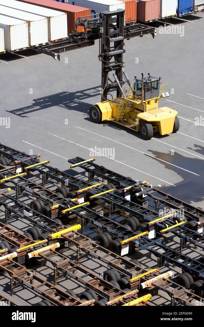 High angle view of a forklift with vehicle trailers and cargo ...