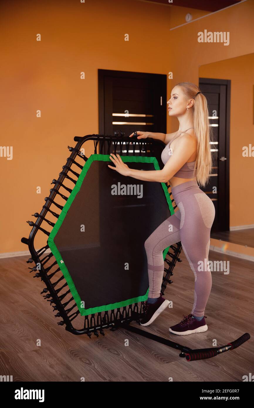 Step fitness woman jumping on mobile mini trampoline Stock Photo - Alamy