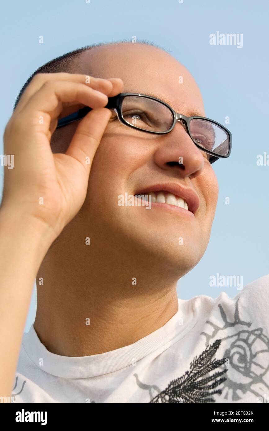Low angle view of a mid adult man smiling Stock Photo - Alamy