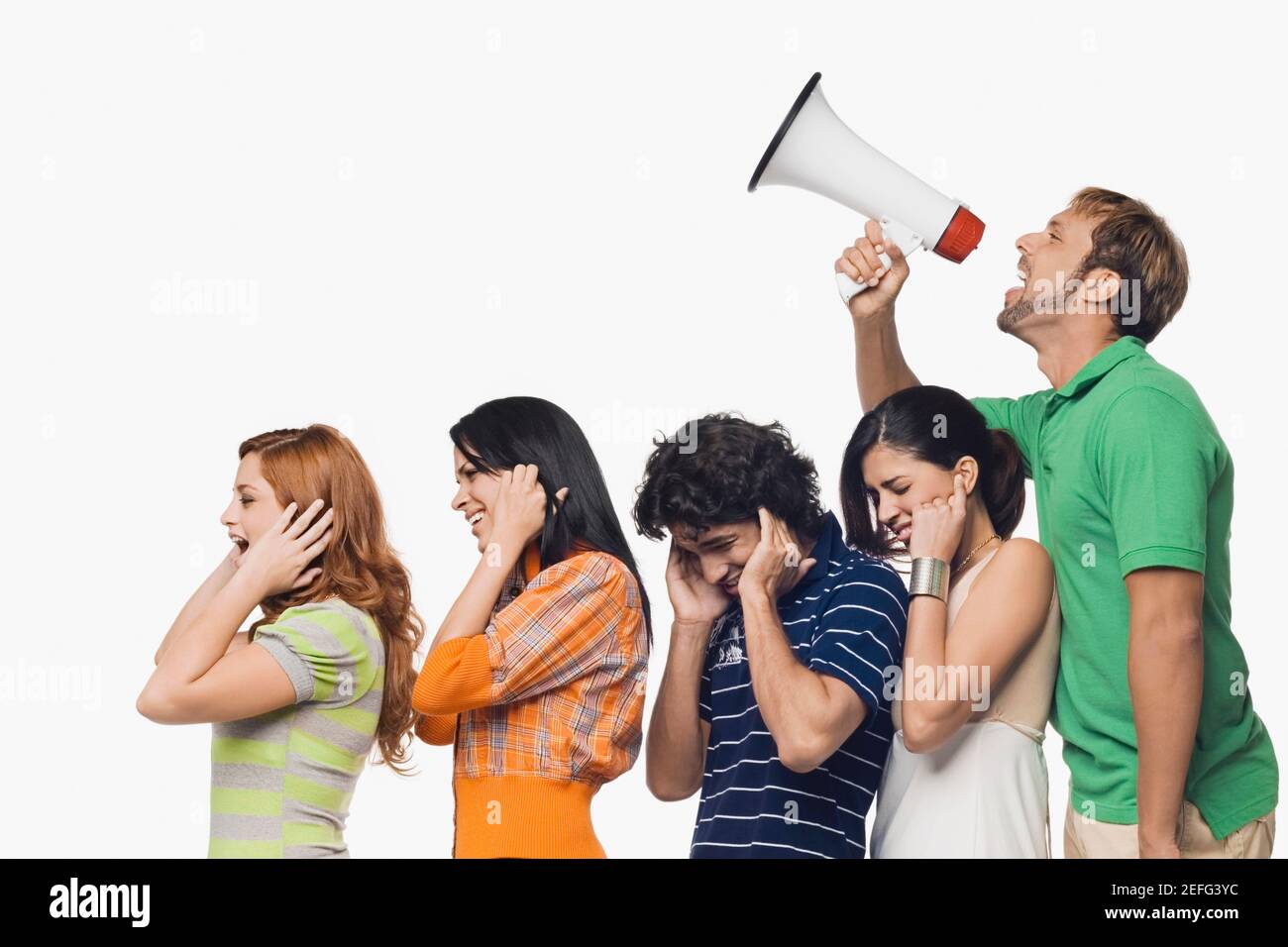 Side profile of a mid adult man shouting into a megaphone behind his ...