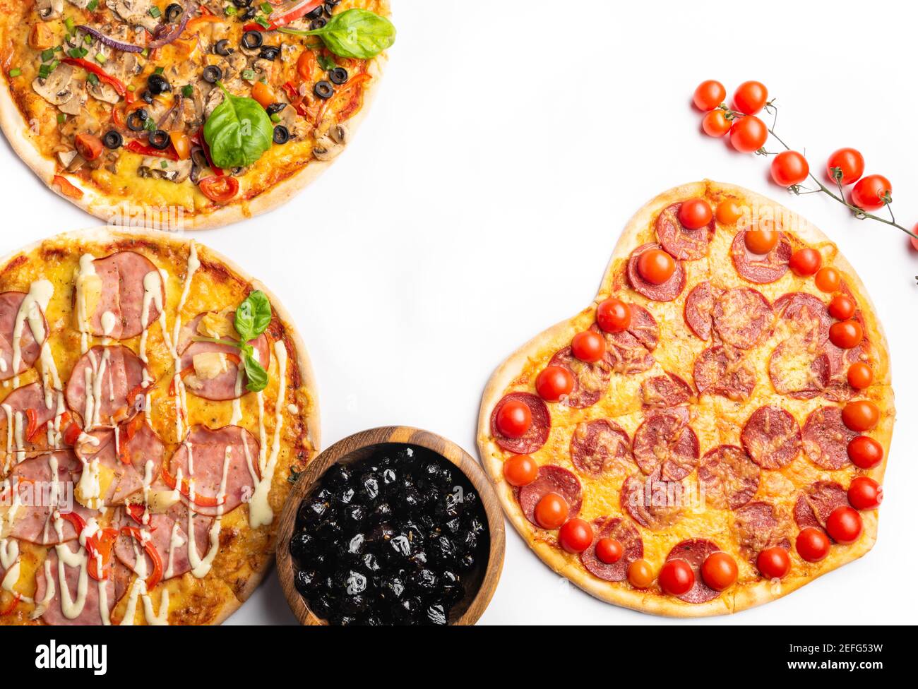 different various kind of pizzas in assortment with green basil ...