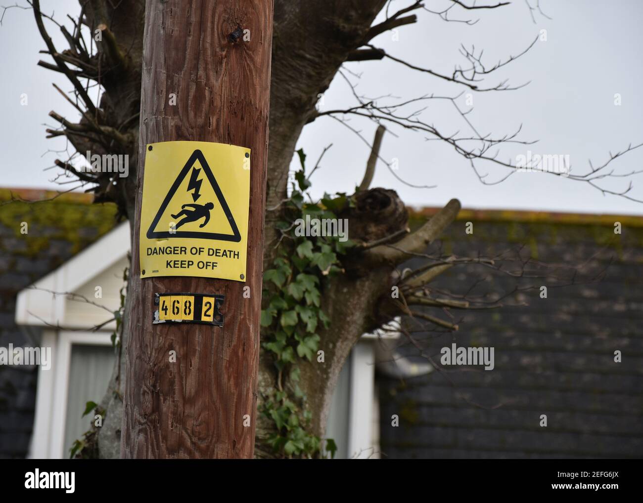 Warning sign on electricity pole hi-res stock photography and images ...