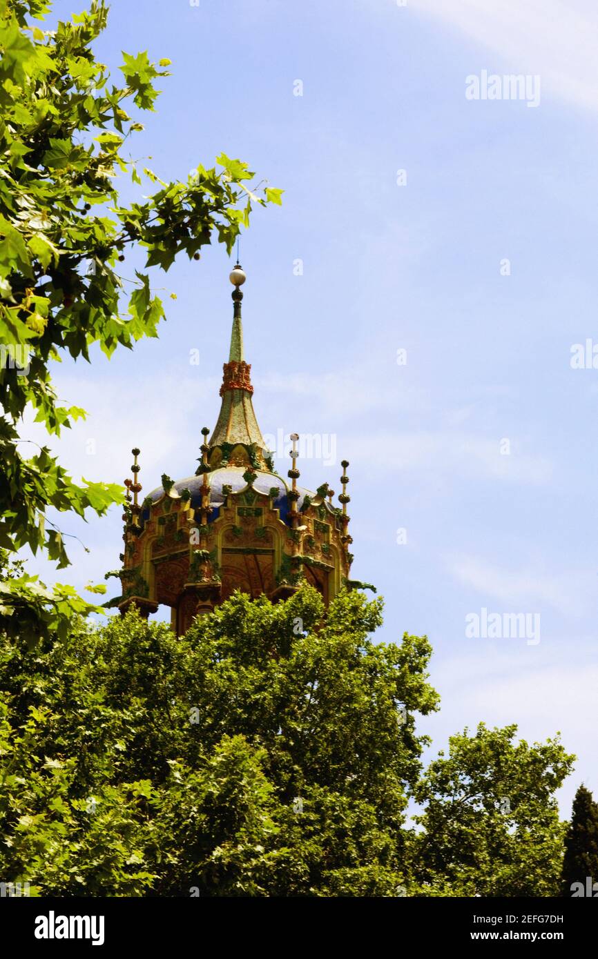 Trees in front of a tower, Barcelona, Spain Stock Photo - Alamy