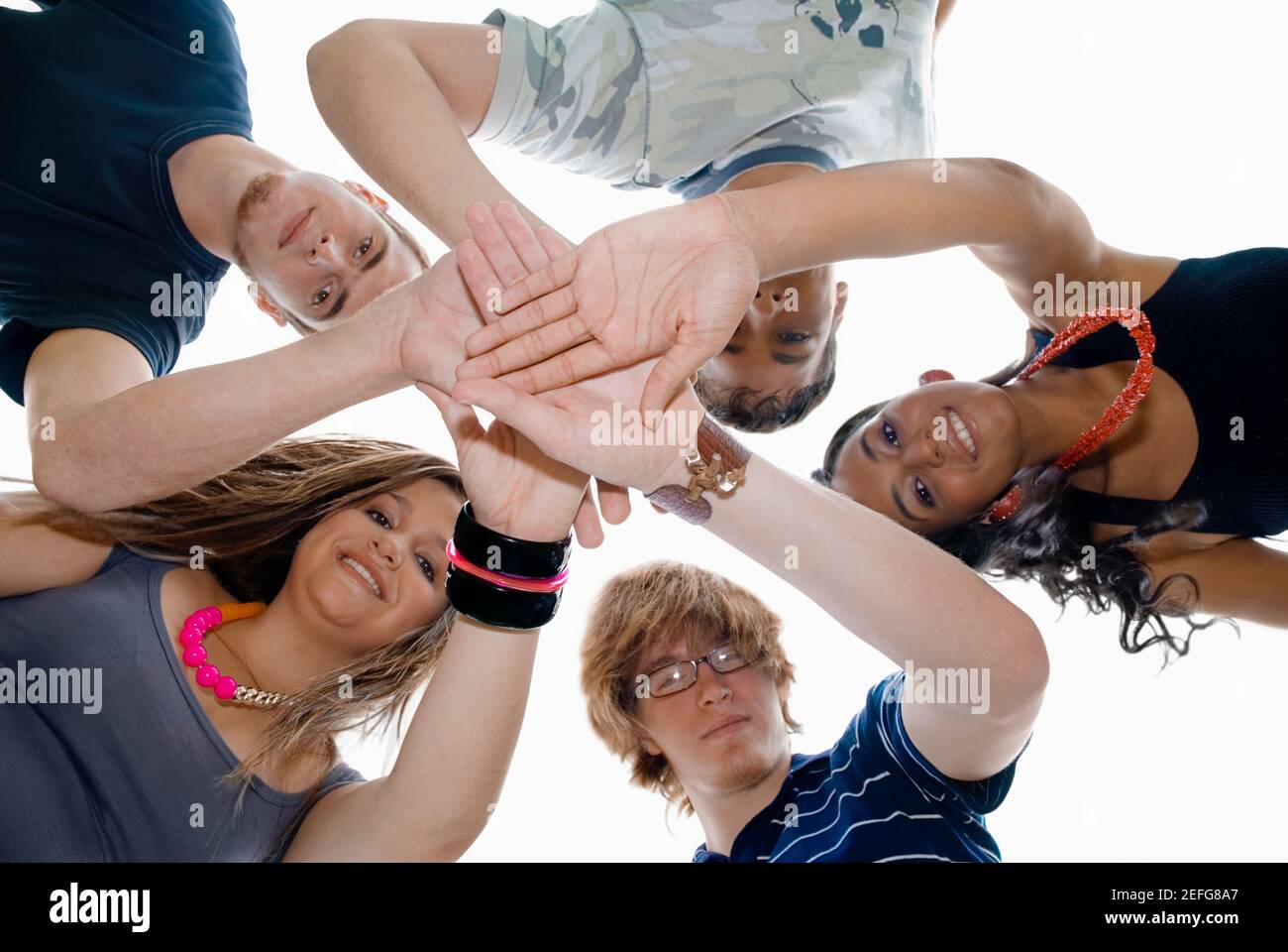 Five friends stacking their hands hi-res stock photography and images ...