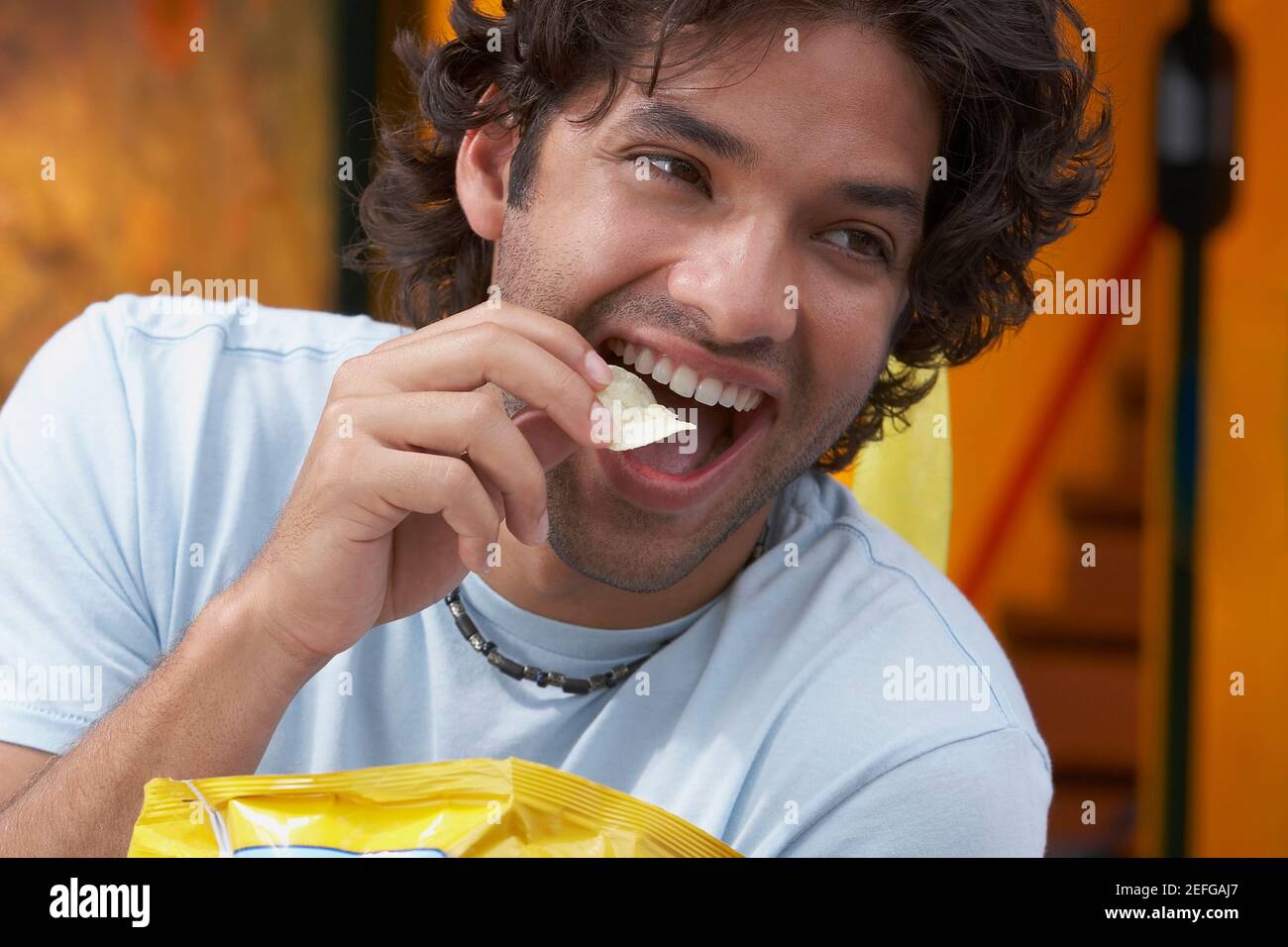Man eating potato chips hi-res stock photography and images - Alamy