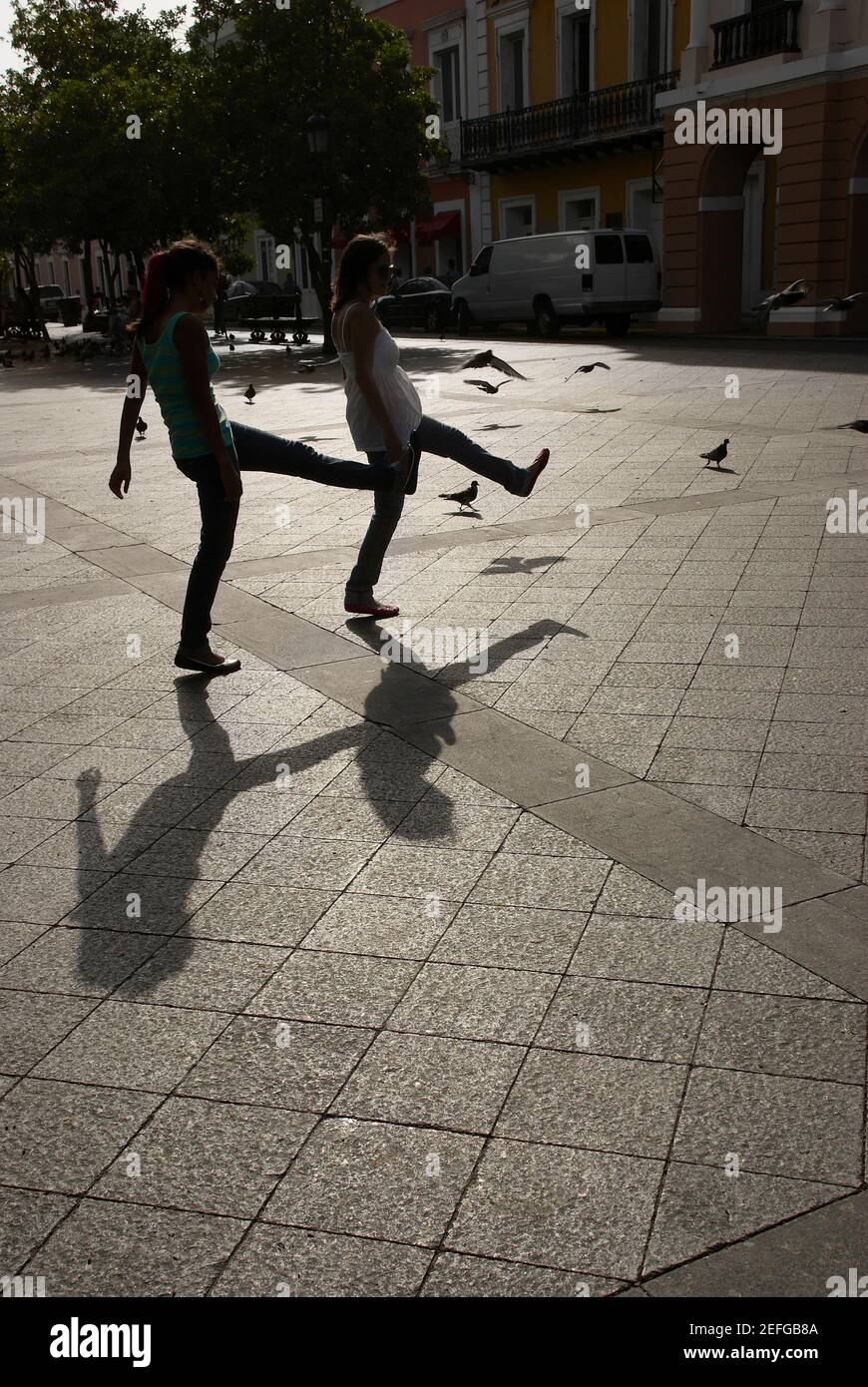 Side profile of two young women walking Stock Photo - Alamy