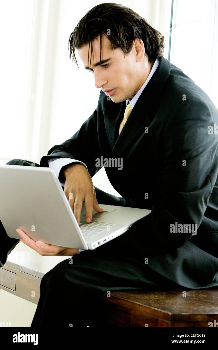 Side profile of a businessman using a laptop Stock Photo - Alamy