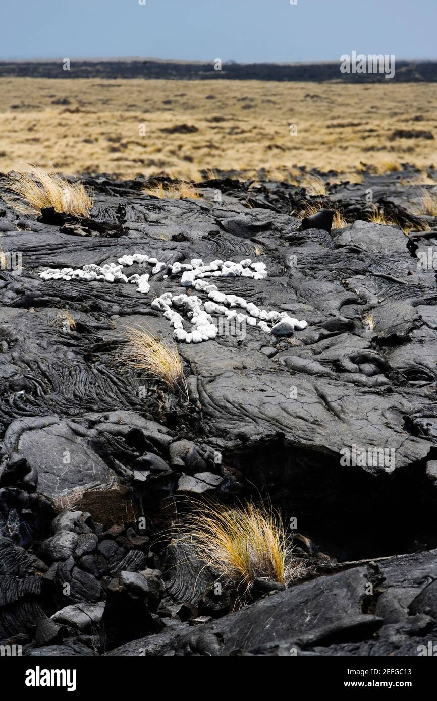 Pebbles representing human shape on a rock, Kona Coast, Big Island ...