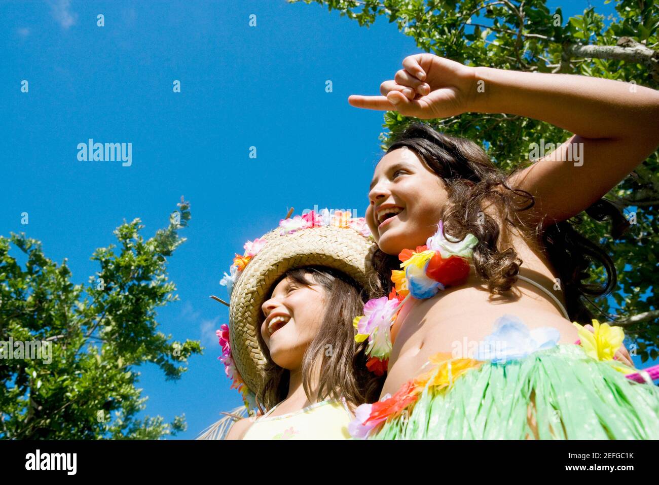 Low angle view of two girls dancing Stock Photo - Alamy