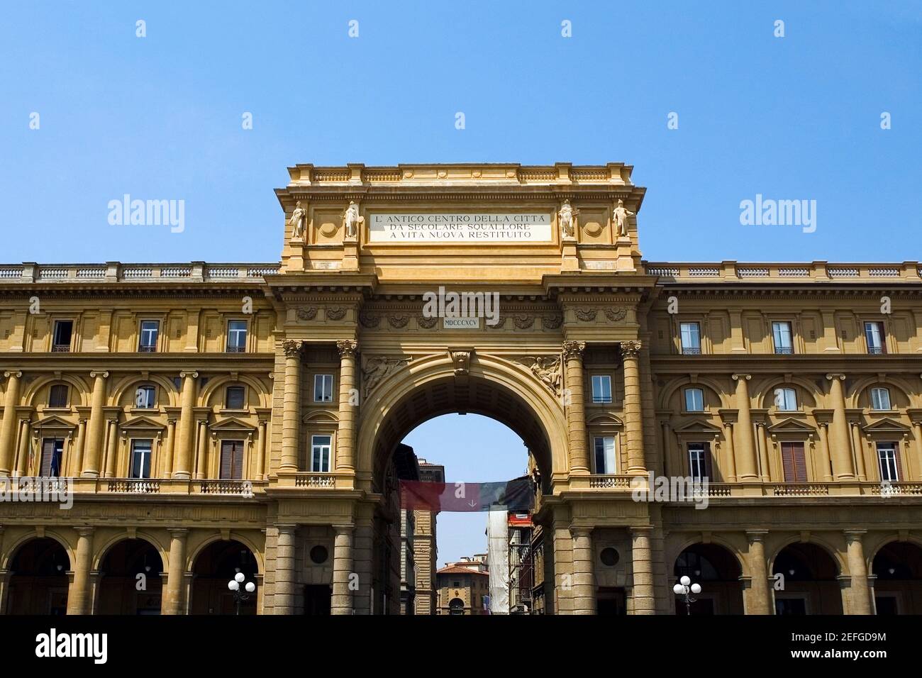 Low angle view of the entrance gate of a market square, Uffizi Museum ...