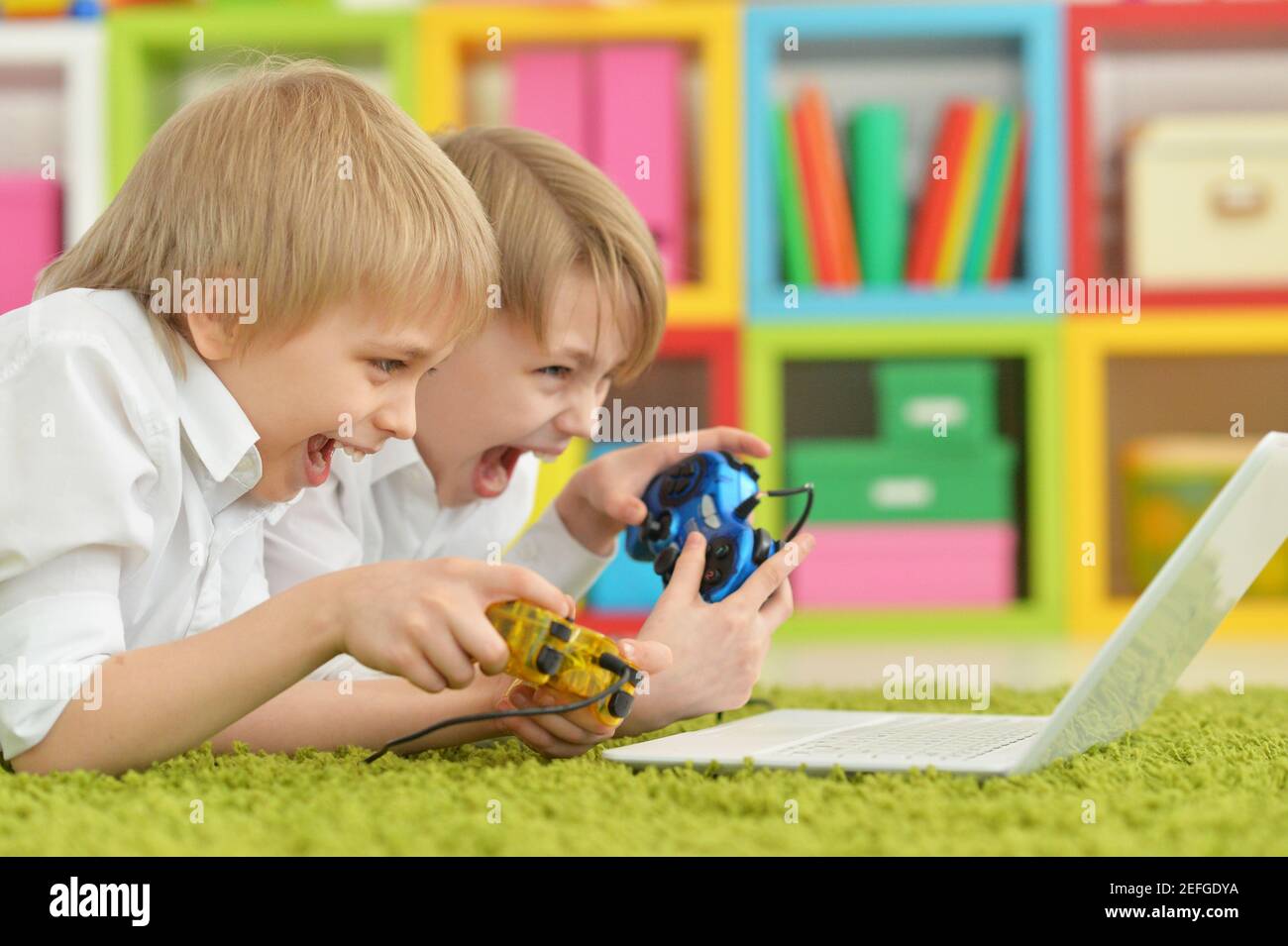 Portrait of two boys playing computer games Stock Photo - Alamy