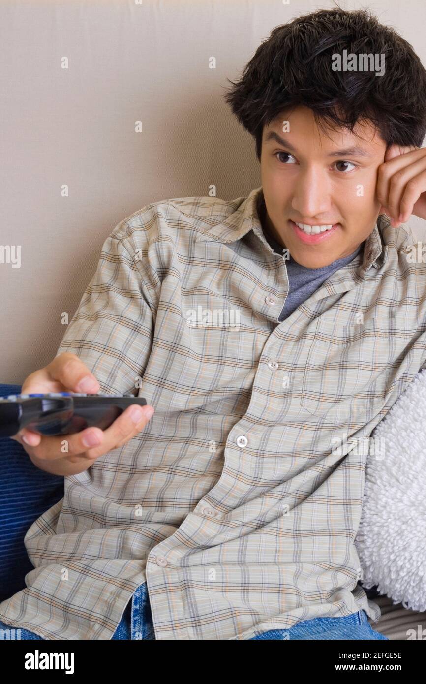 Close-up of a young man operating a remote control Stock Photo - Alamy