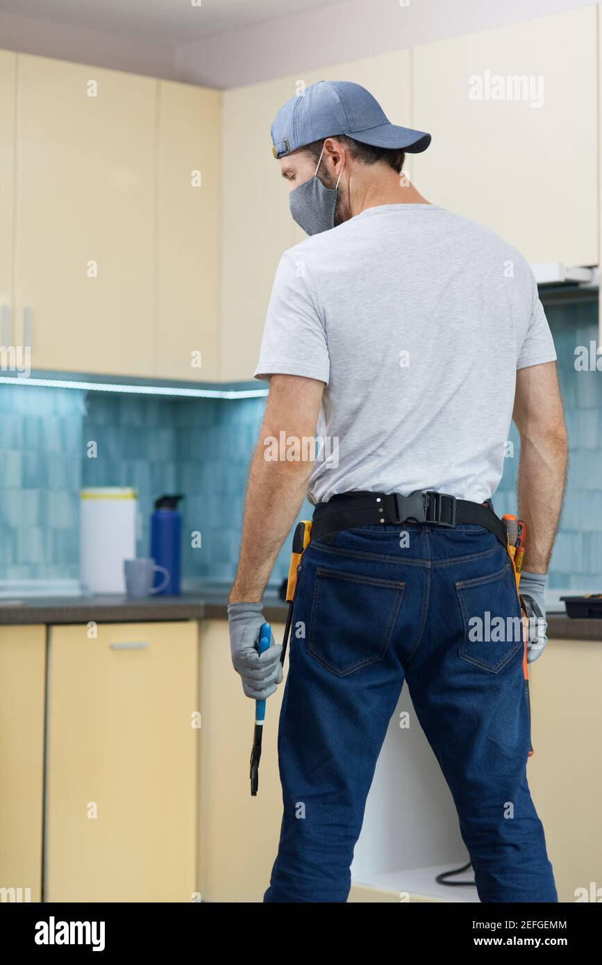 Repairman wearing mask home hi-res stock photography and images - Alamy