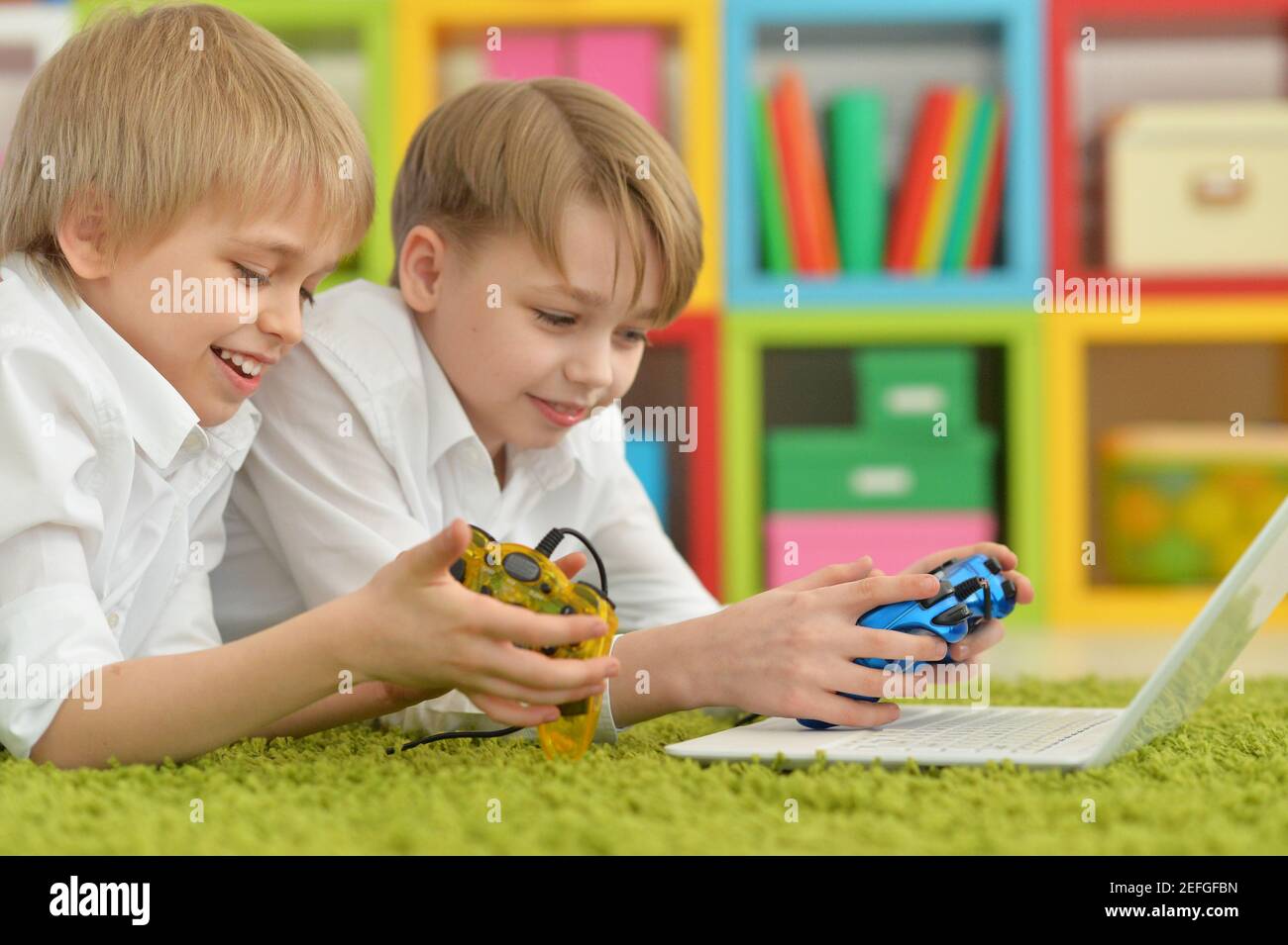 Portrait of two boys playing computer games Stock Photo - Alamy