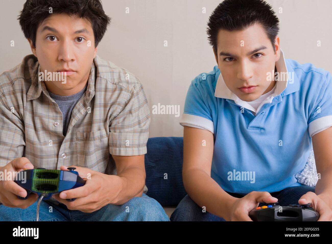 Two young men playing video game Stock Photo - Alamy