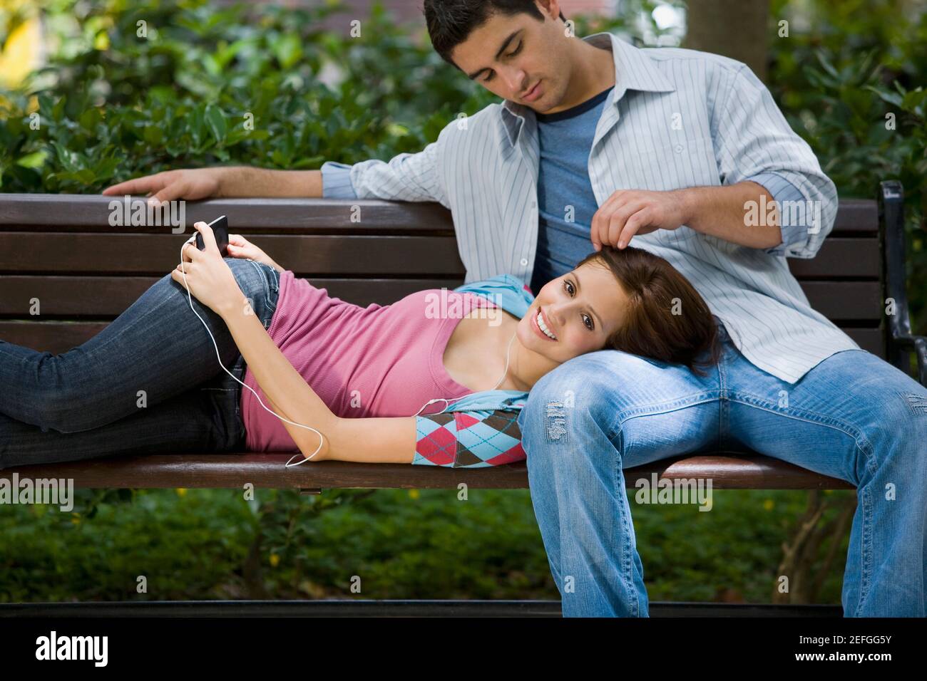 Young couple romancing in a park Stock Photo - Alamy