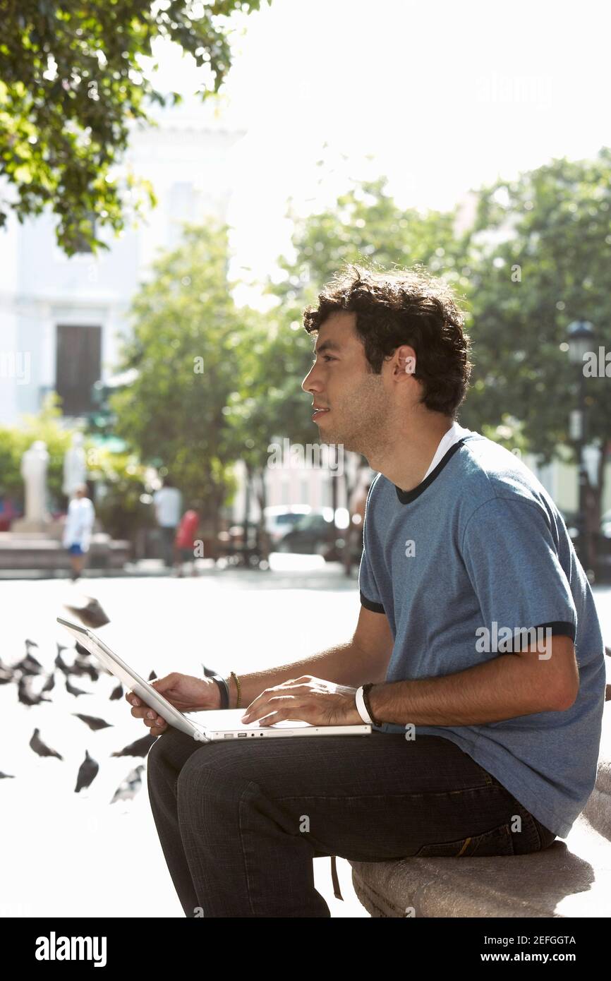 Side profile of a man working on a computer hi-res stock photography ...