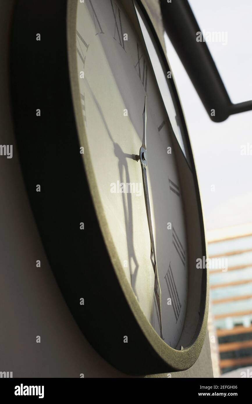Close-up of a clock hanging on a wall Stock Photo - Alamy