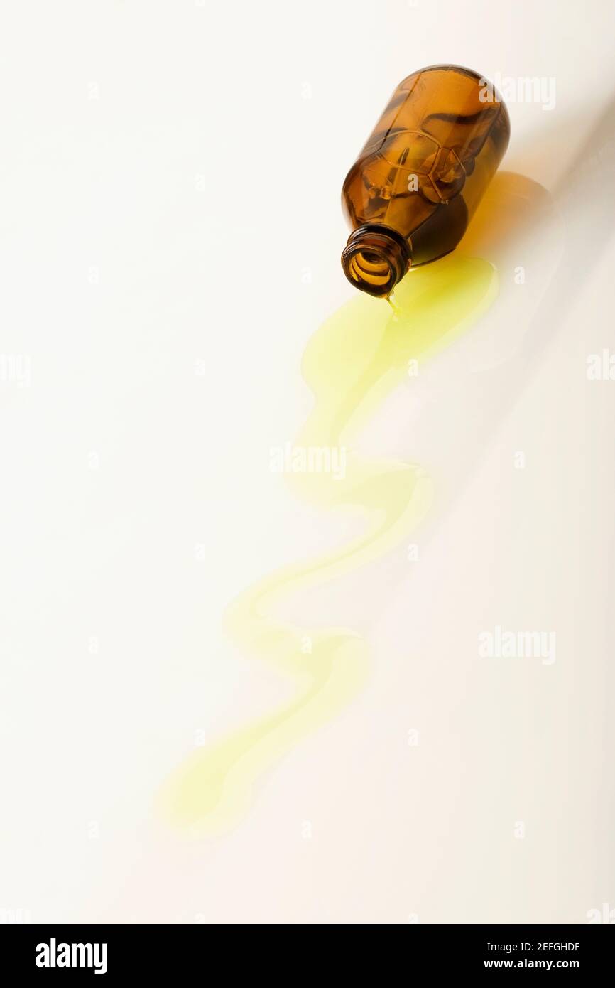 Medicine spilling from a vial Stock Photo - Alamy