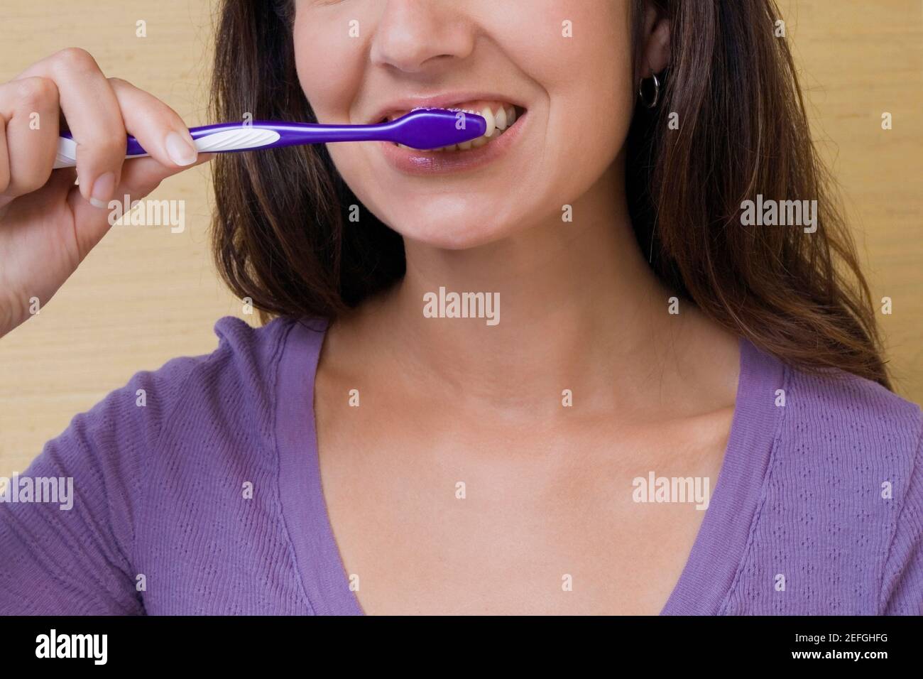 Mid section view of a mid adult woman brushing her teeth Stock Photo ...