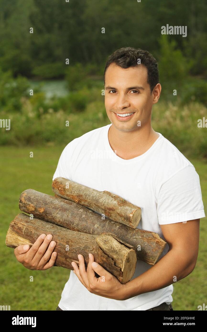 Young man carrying firewood hi-res stock photography and images - Alamy