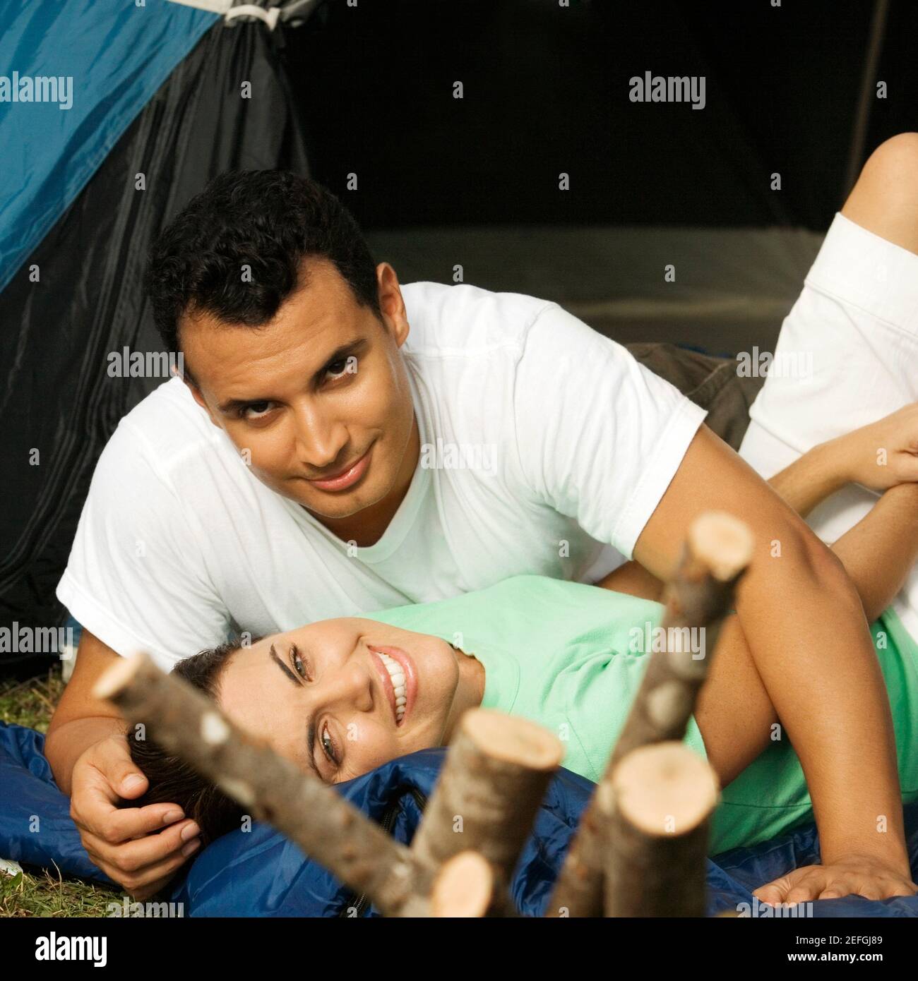 Portrait of a young man lying in a tent Stock Photo - Alamy