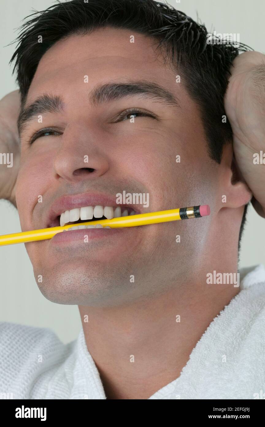 Angry man biting pencil hi-res stock photography and images - Alamy