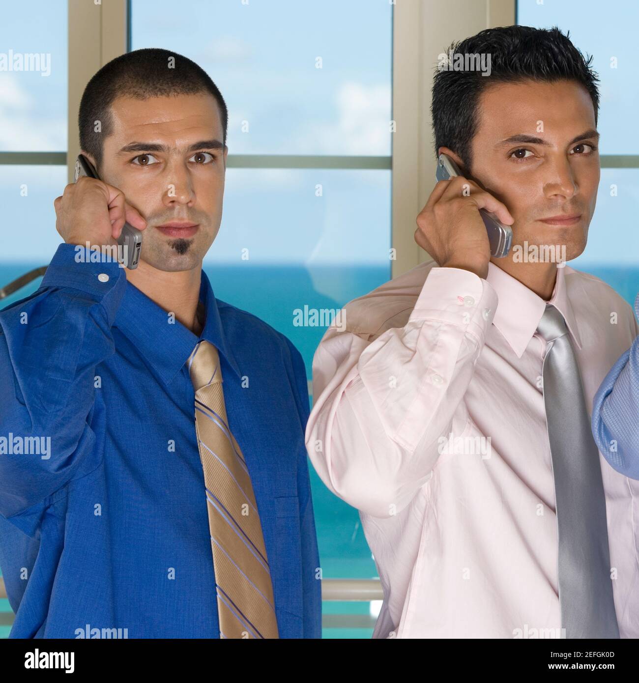 Two businessmen looking at cell hi-res stock photography and images - Alamy