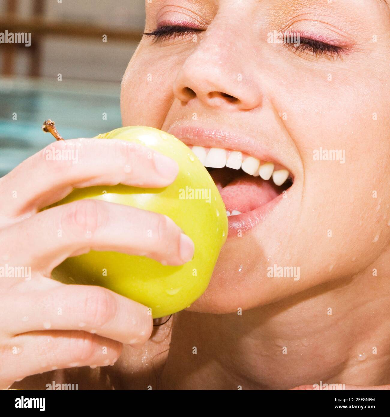 Young woman apple in mouth hi-res stock photography and images - Alamy