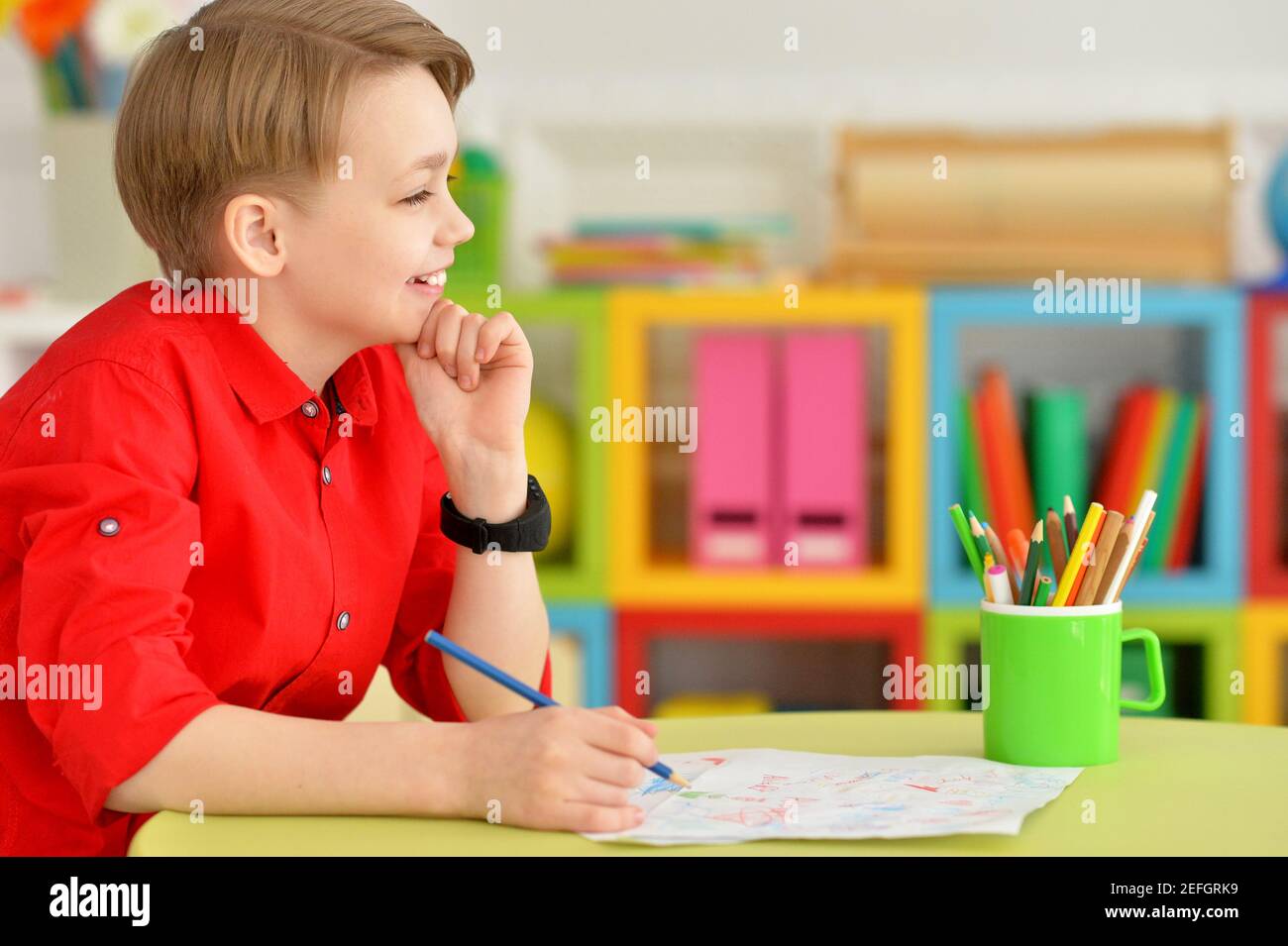 Portrait of cute little boy drawing with pencils Stock Photo - Alamy