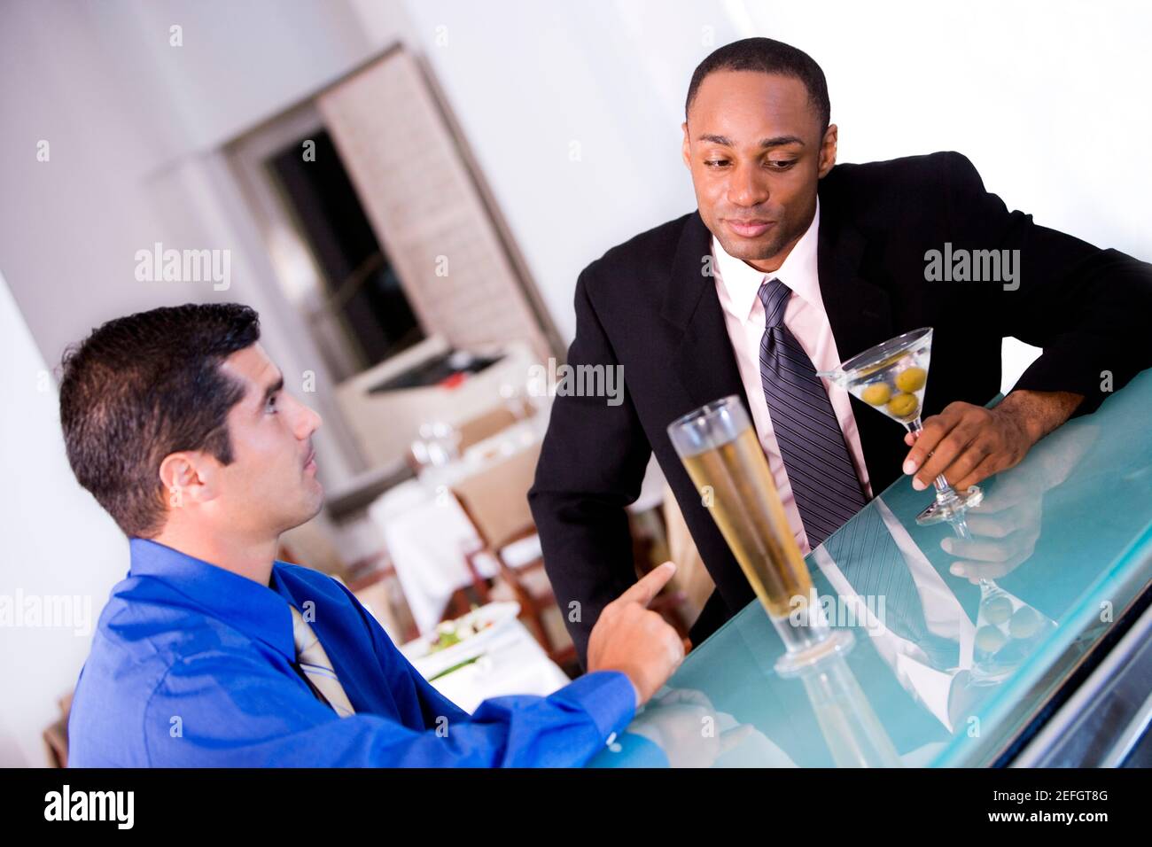 Two businessmen sitting in a bar hi-res stock photography and images ...