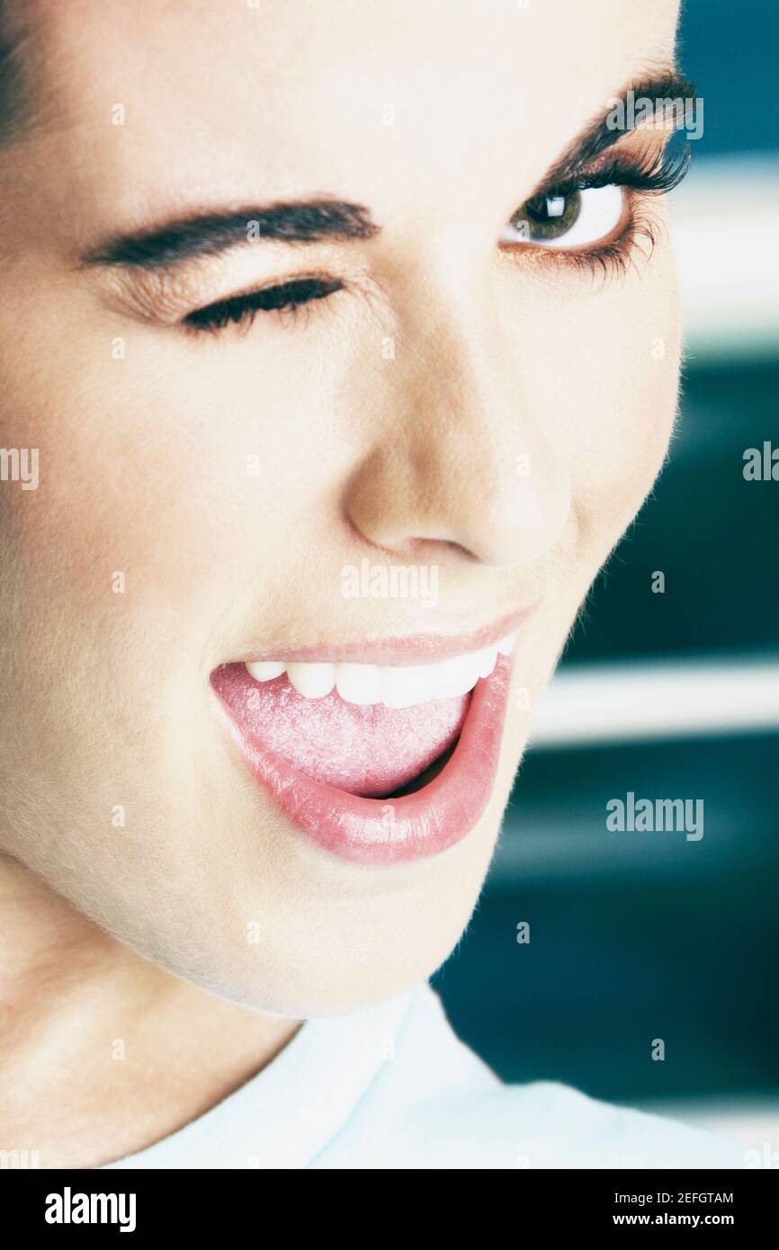 Portrait of a young woman winking Stock Photo - Alamy