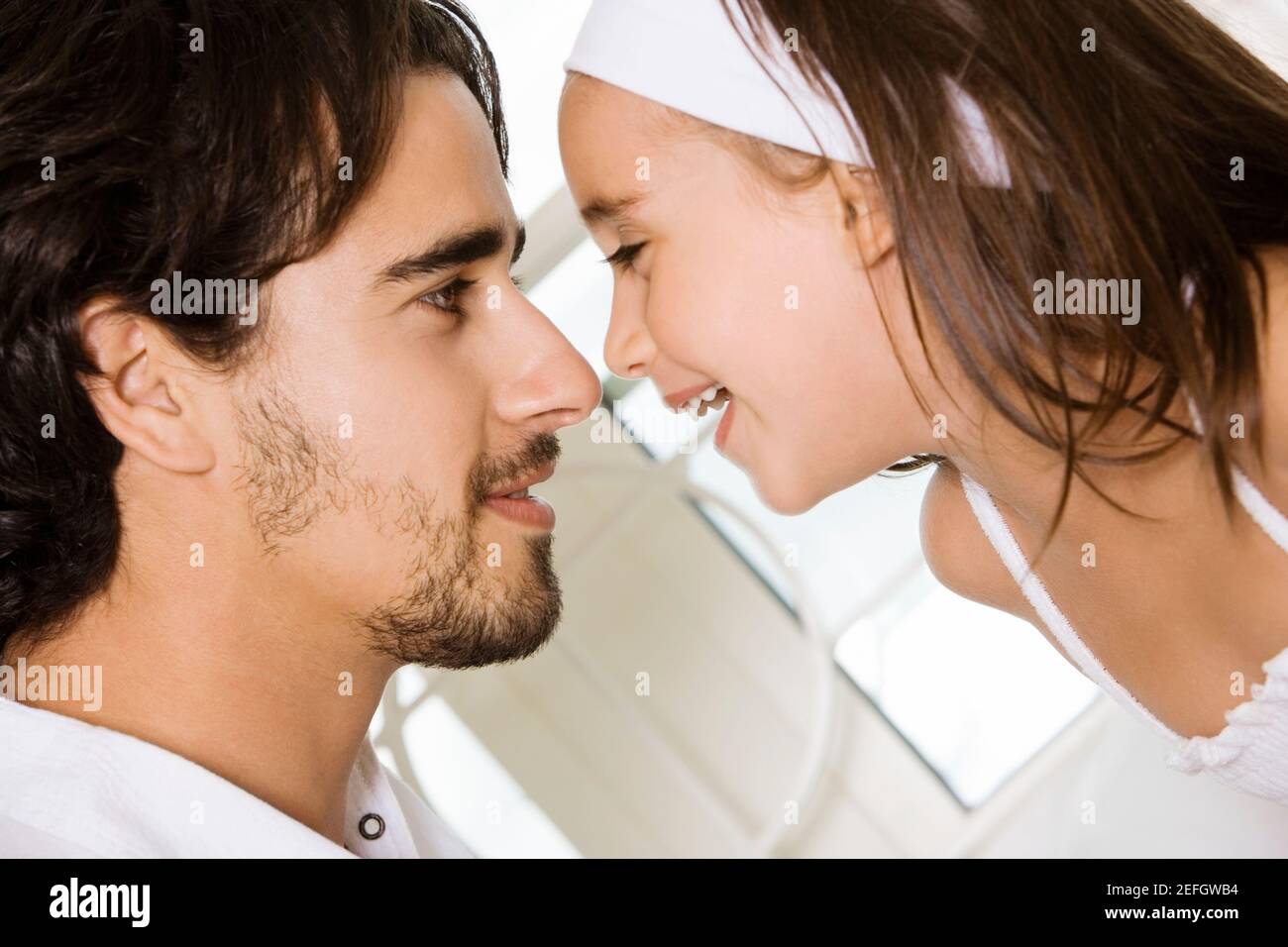 Side profile of a father looking at his daughter Stock Photo - Alamy
