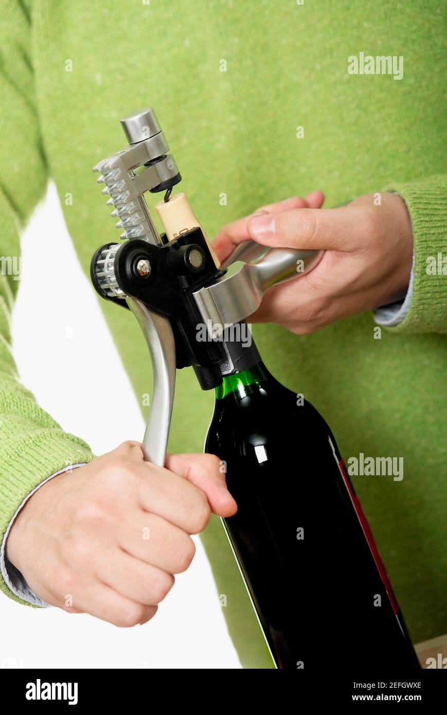 Mid section view of a man opening the cork of a wine bottle Stock Photo ...