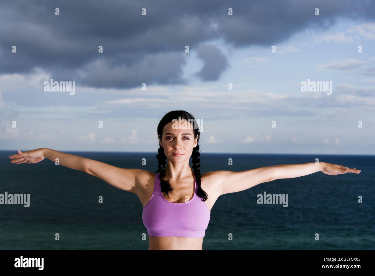 Portrait of a young woman with her arms outstretched Stock Photo - Alamy