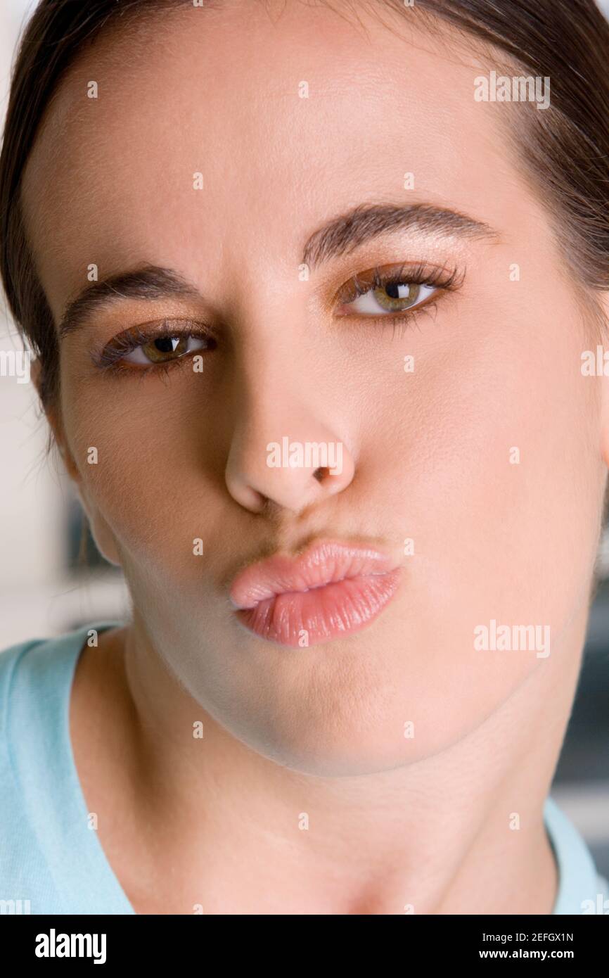 Close-up of a young woman puckering her lips Stock Photo - Alamy