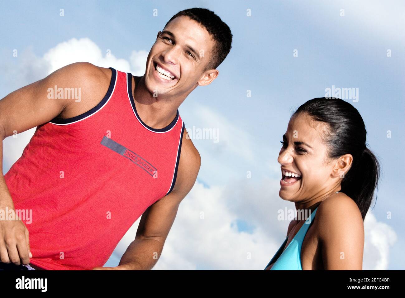 Low angle view of a young couple laughing Stock Photo - Alamy