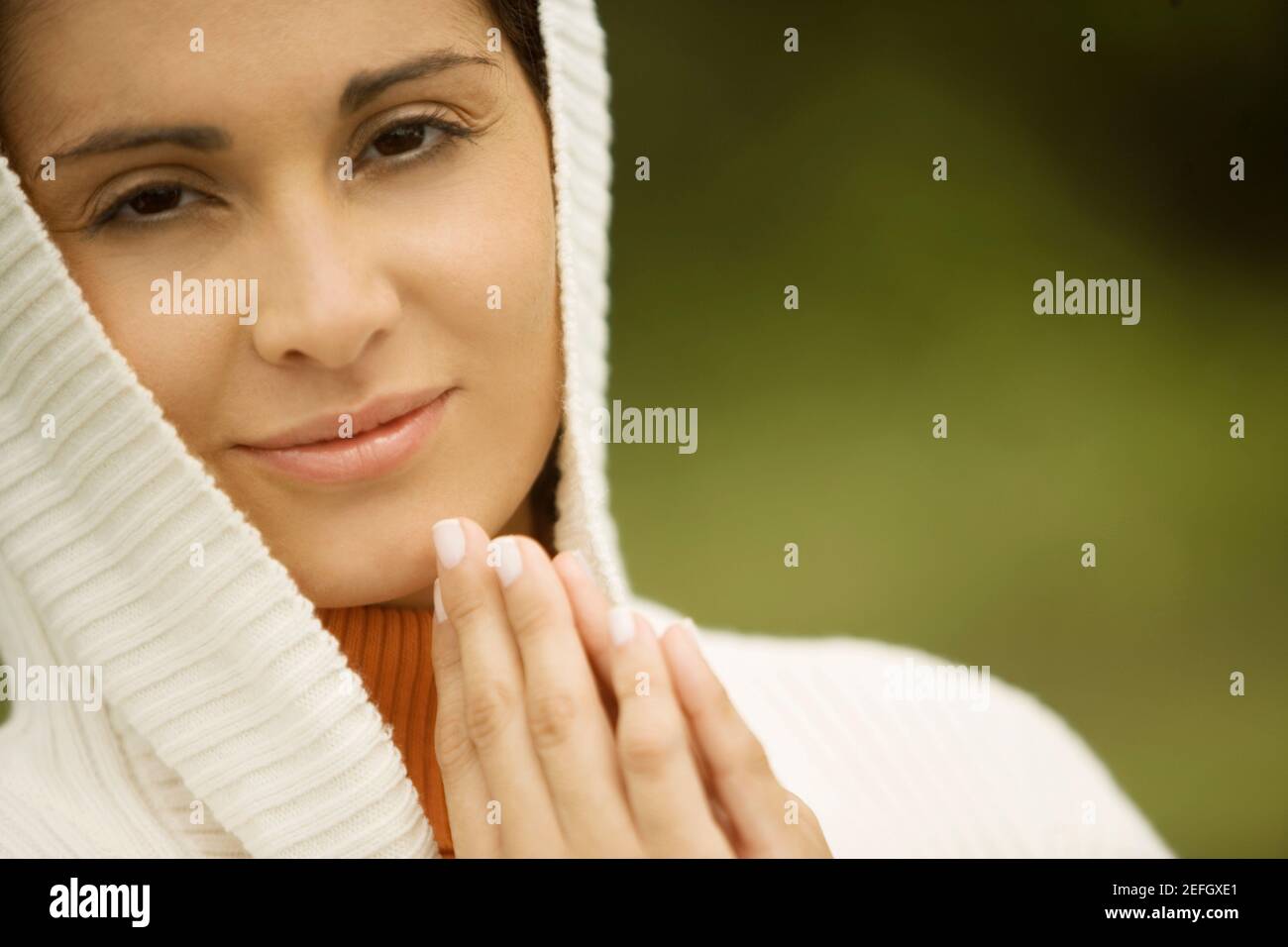 Portrait of a young woman smiling in a prayer position Stock Photo - Alamy