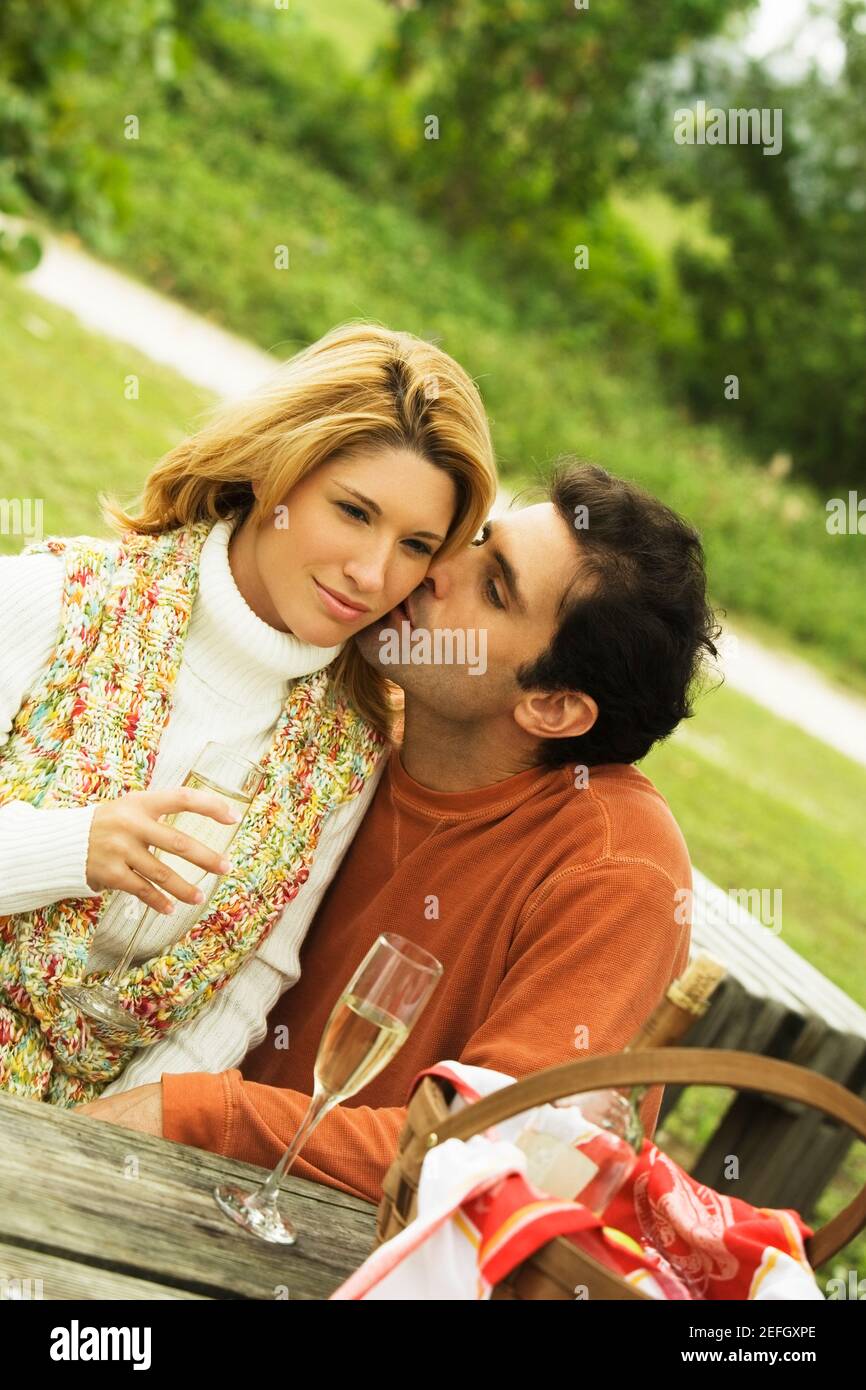 Mid adult man kissing a young woman Stock Photo - Alamy