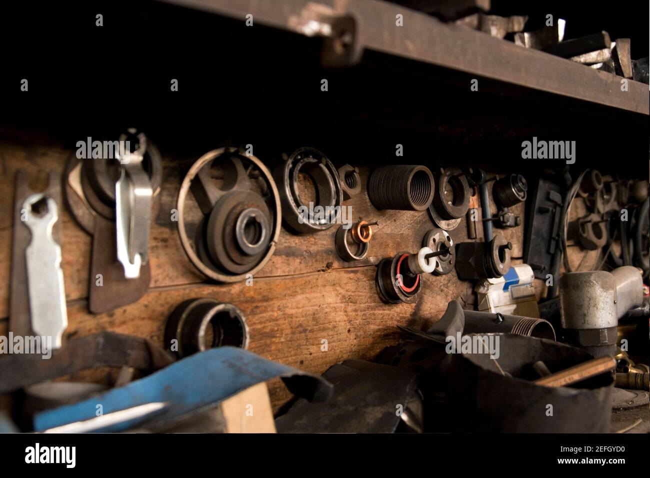 Old wooden workshop bench with spare parts Stock Photo - Alamy