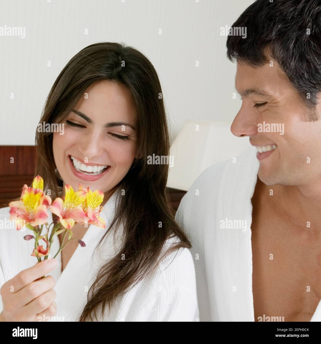 Close-up of a young woman and a mid adult man looking at flowers Stock ...