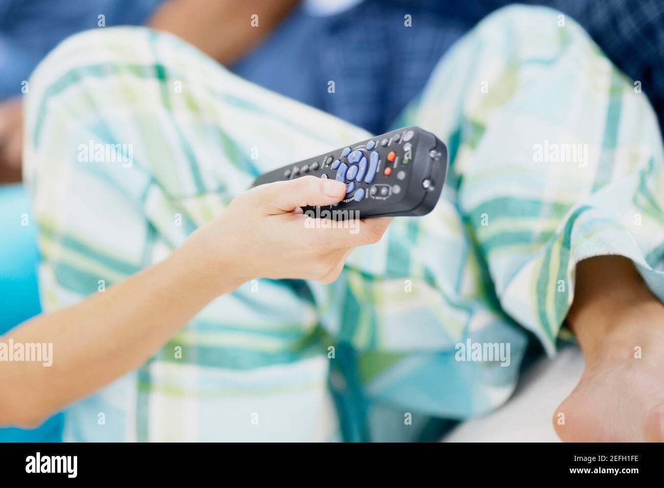 Holding a remote control hi-res stock photography and images - Alamy